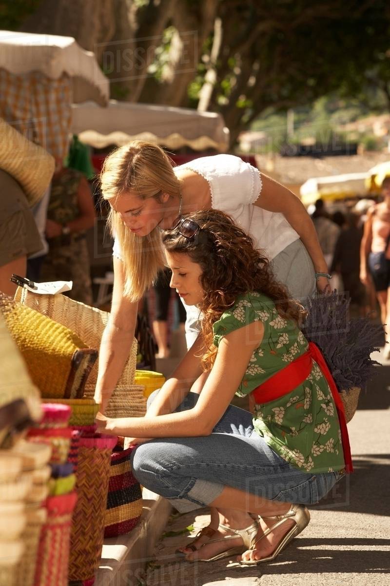 Two girls shopping in market - Stock Photo - Dissolve