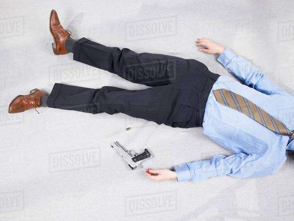 Man lying on floor with gun - Royalty-free Stock Photo | Dissolve
