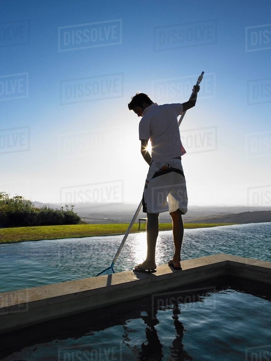 Man cleaning swimming pool - Royalty-free Stock Photo | Dissolve