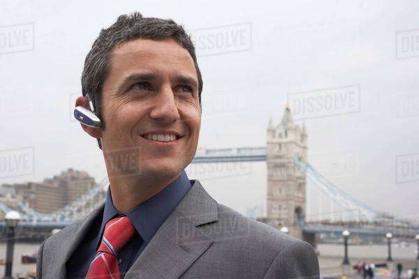 Man with bluetooth headset outside - Royalty-free Stock Photo | Dissolve