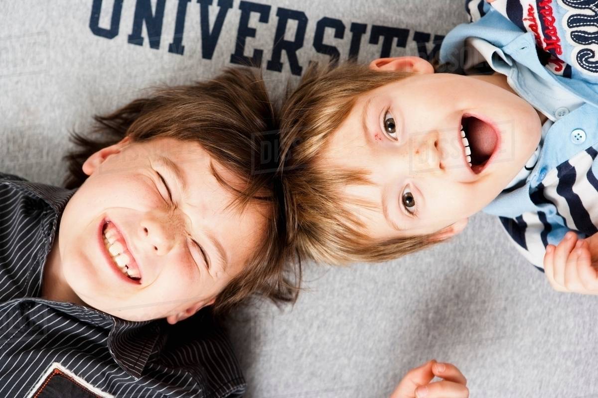 Two brothers laughing - Stock Photo - Dissolve