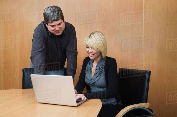 Man mentoring woman colleague - Stock Photo - Dissolve
