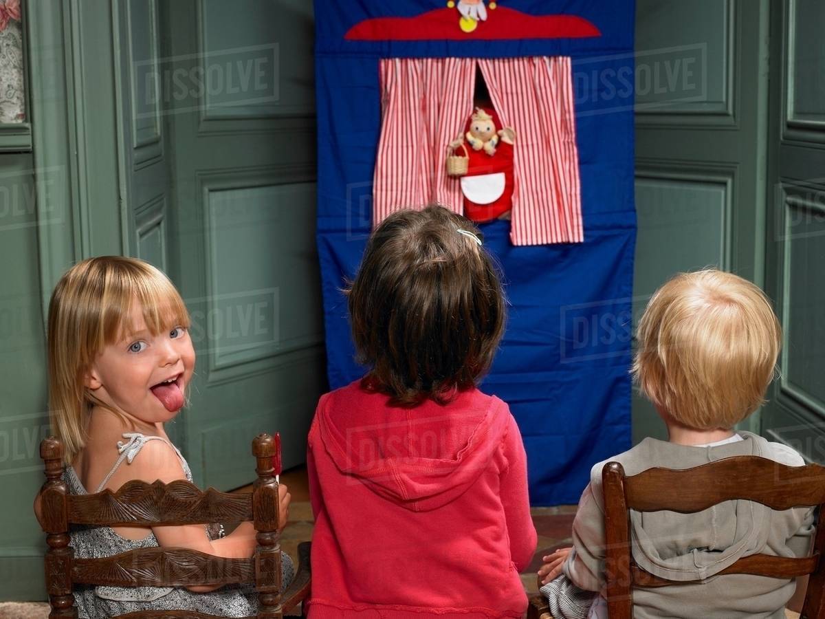 Kids watching a puppet show - Stock Photo - Dissolve