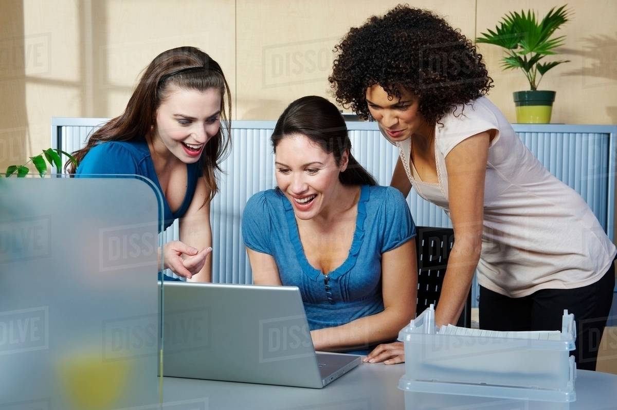 Group of young women with laptop at desk - Royalty-free Stock Photo ...