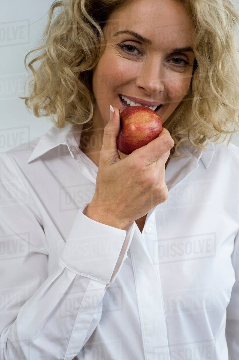 Woman eating - Royalty-free Stock Photo | Dissolve