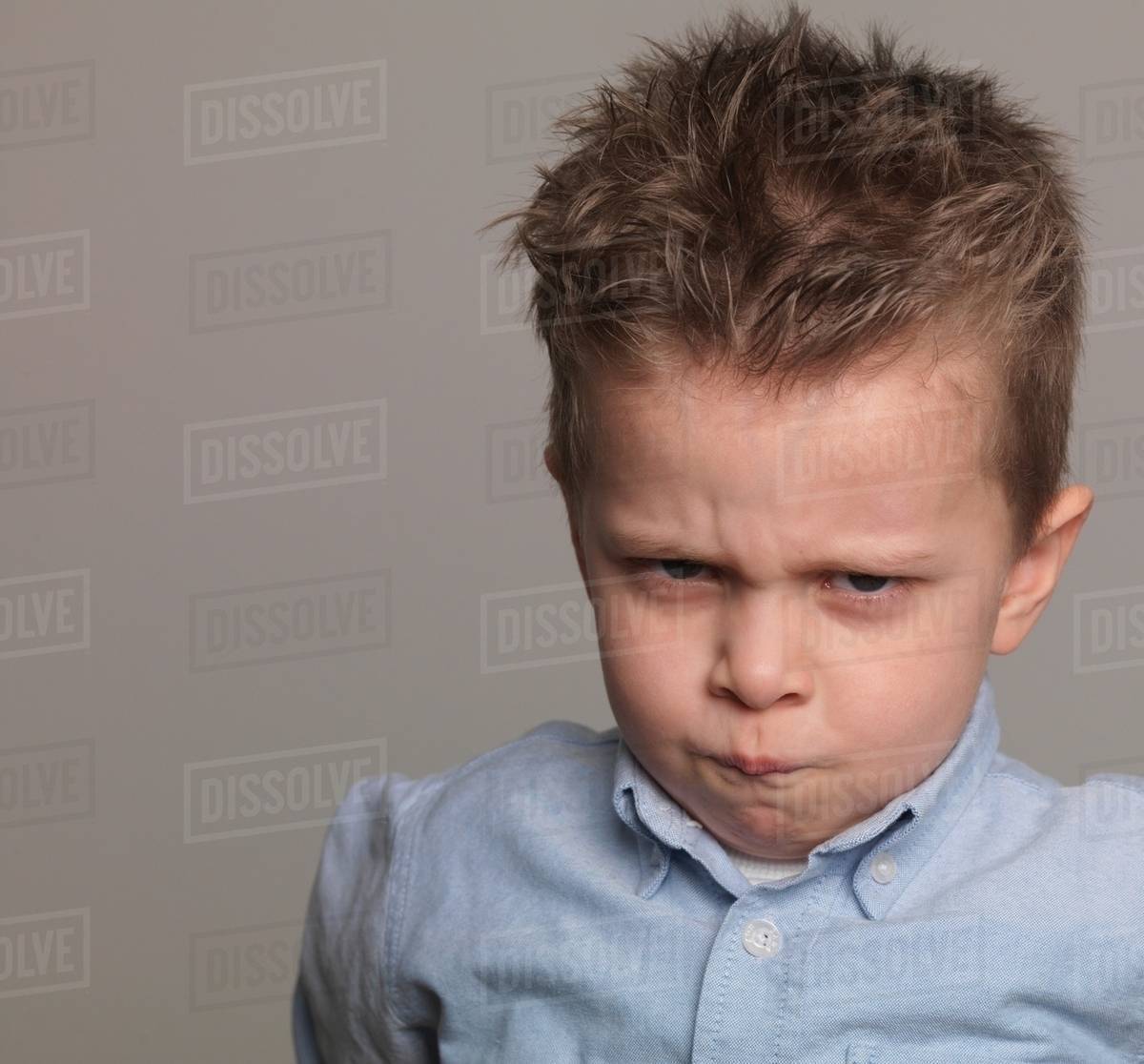 Boy frowning, portrait, close-up - Stock Photo - Dissolve