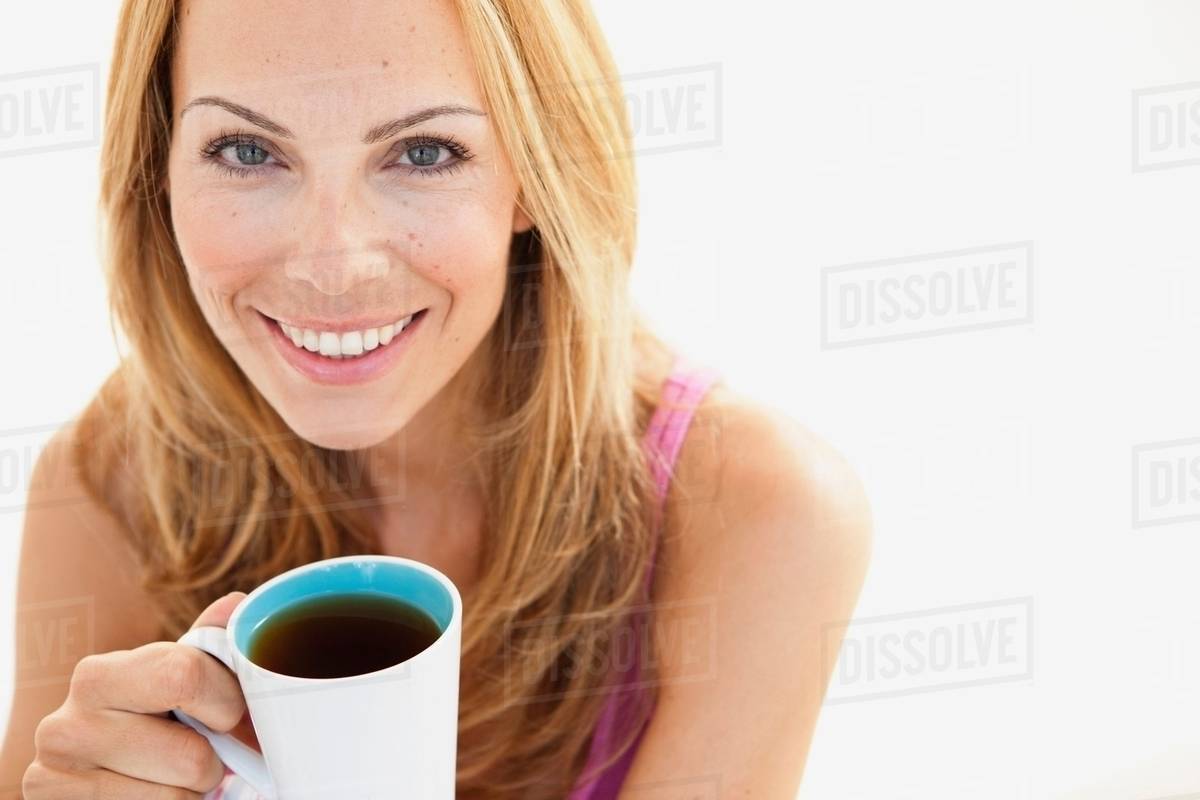 Young woman with cup of tea portrait - Royalty-free Stock Photo | Dissolve