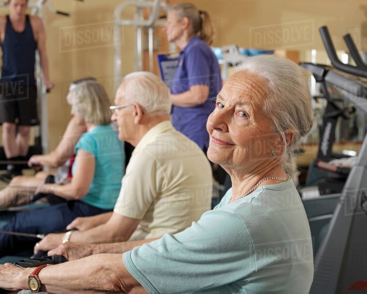 Seniors training at gym with instructor - Royalty-free Stock Photo ...