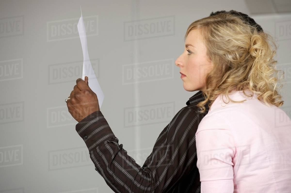 Office workers reading papers - Royalty-free Stock Photo | Dissolve