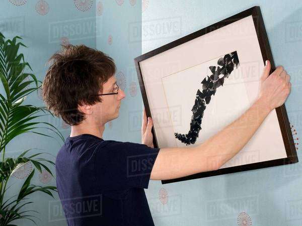 Man carrying rolled rug - Royalty-free Stock Photo | Dissolve