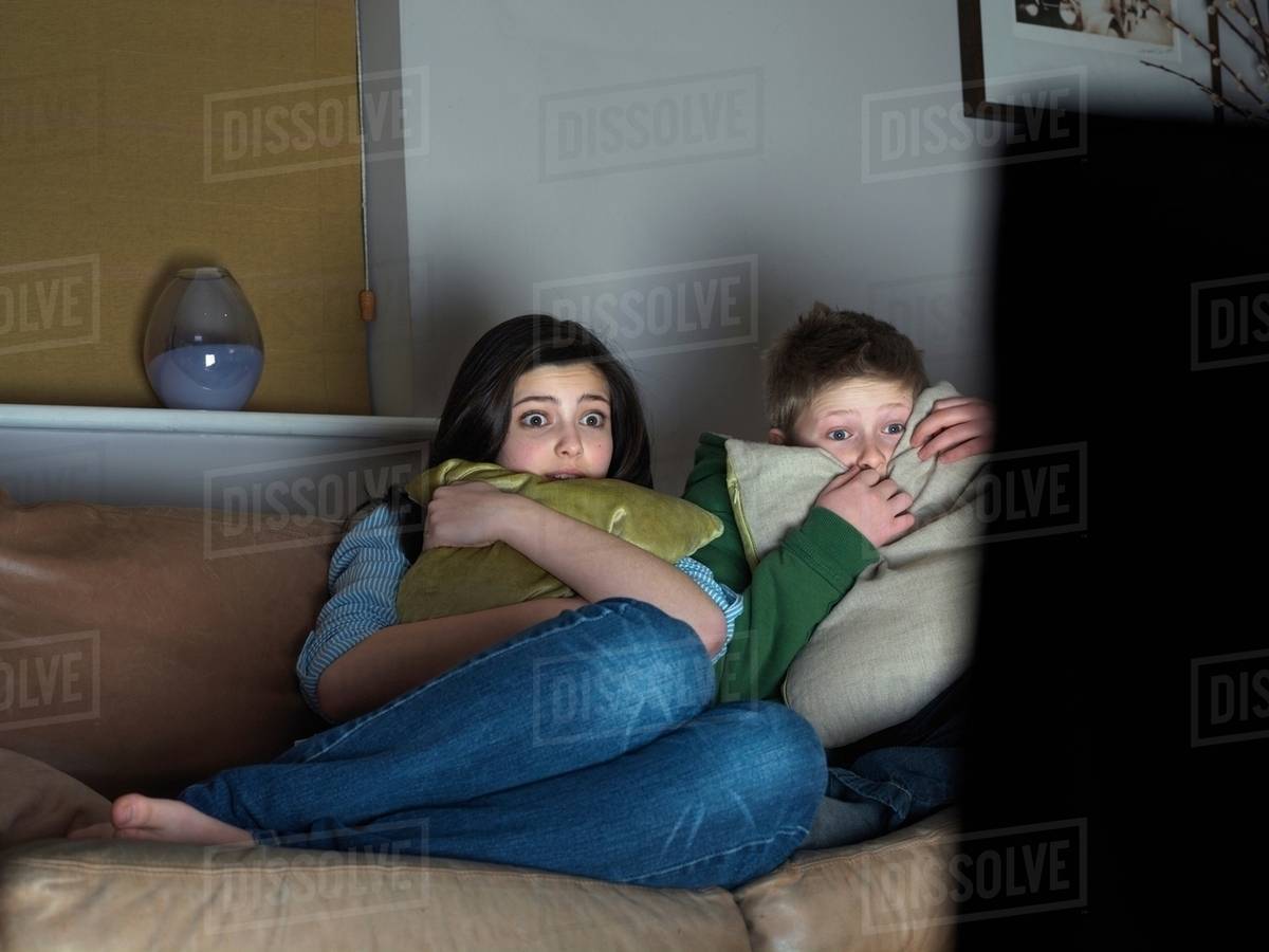 Brother and sister watching scary movie - Royalty-free Stock Photo ...