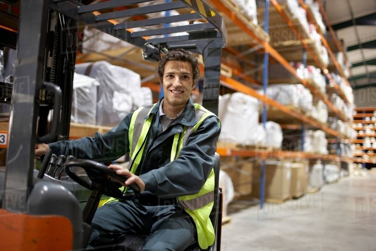 Worker on forklift, smiling to camera - Royalty-free Stock Photo | Dissolve