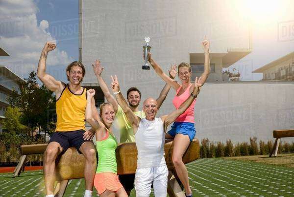 Portrait of gymnast team celebrating winners trophy - Stock Photo ...