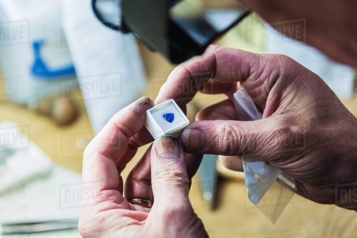 Close up of jewellery craftsman examining gemstone - Royalty-free Stock ...
