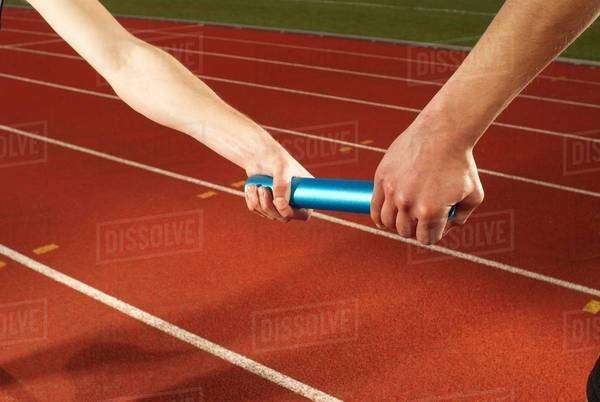 Relay baton being exchanged - Royalty-free Stock Photo | Dissolve