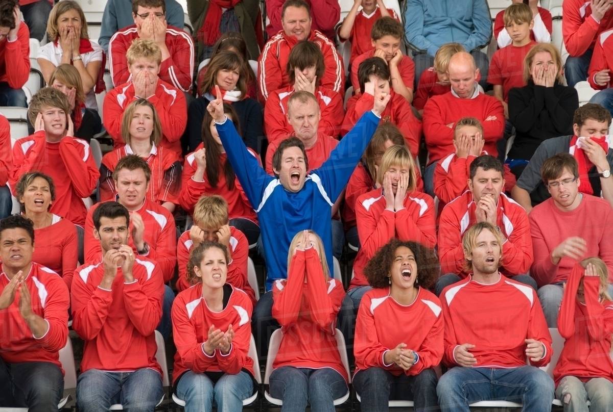 Fan amongst rivals at football match - Royalty-free Stock Photo | Dissolve