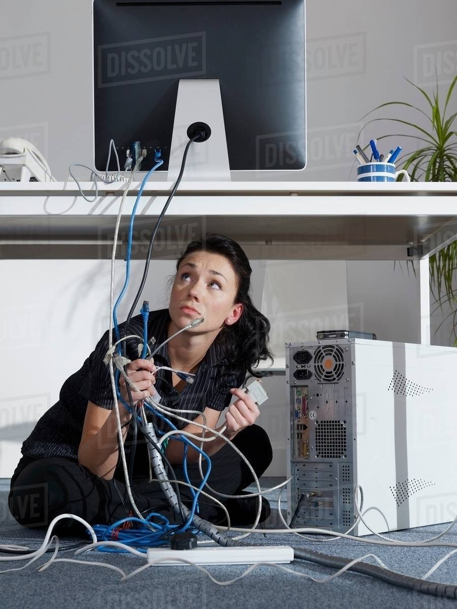 An office girl tries to fix her computer - Stock Photo - Dissolve