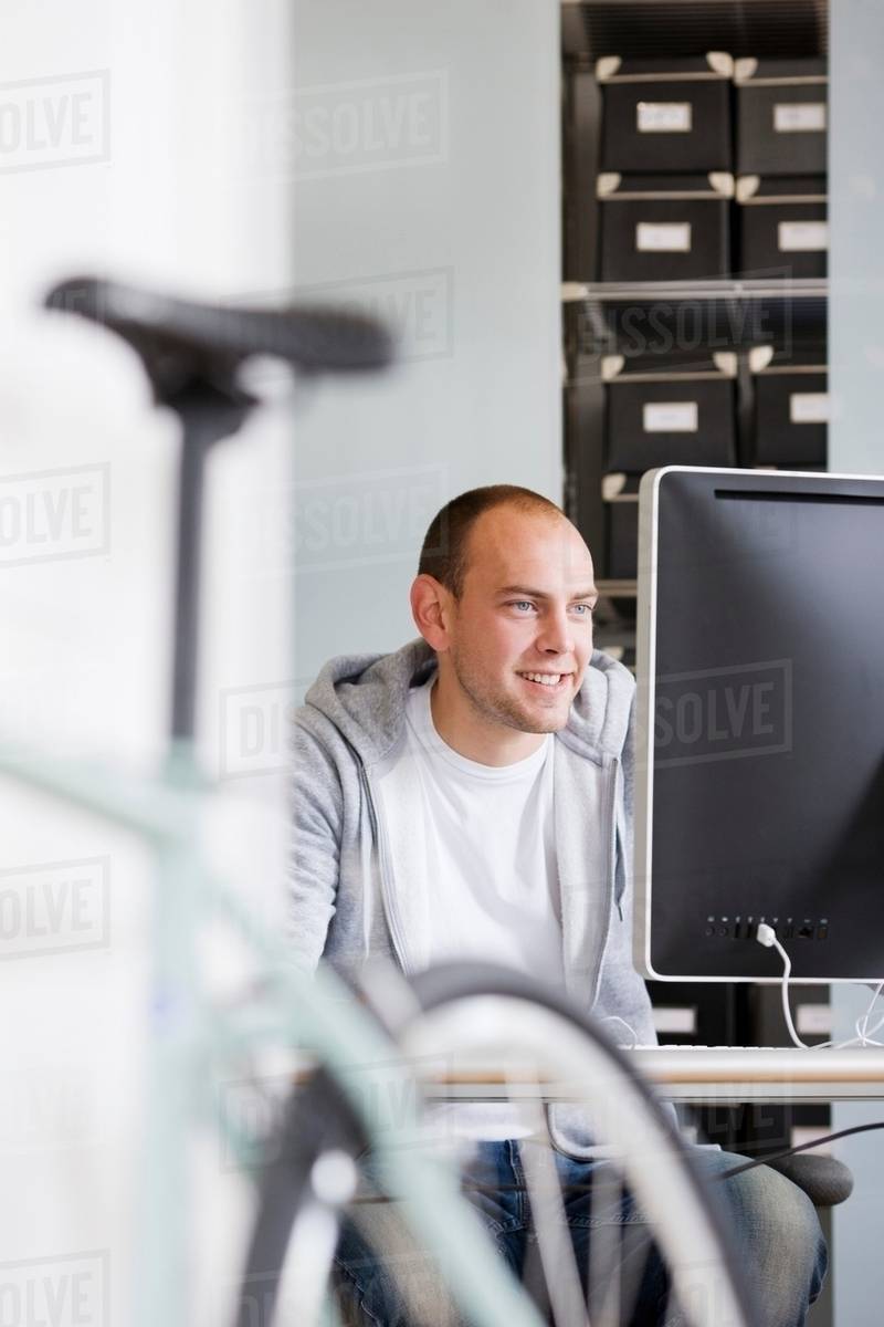 Man sitting at desk working - Stock Photo - Dissolve