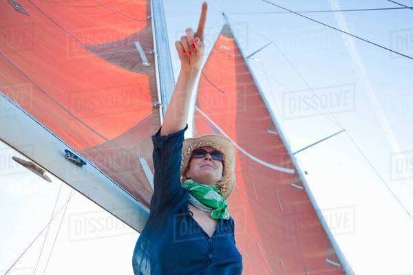 Woman on a ship pointing with finger - Stock Photo - Dissolve