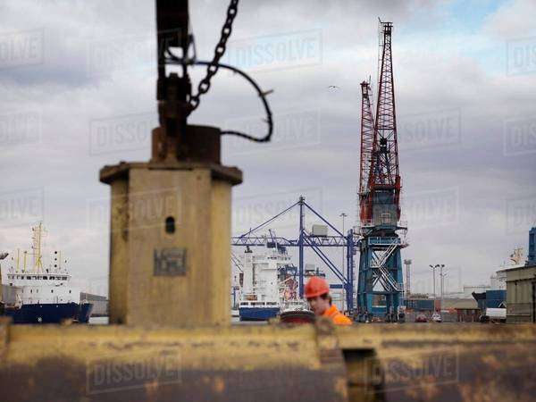 Port Worker With Pulleys And Cranes - Stock Photo - Dissolve