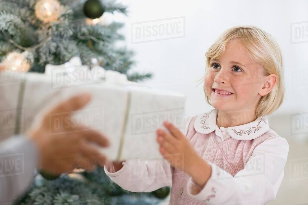 Little girl getting a present - Royalty-free Stock Photo | Dissolve