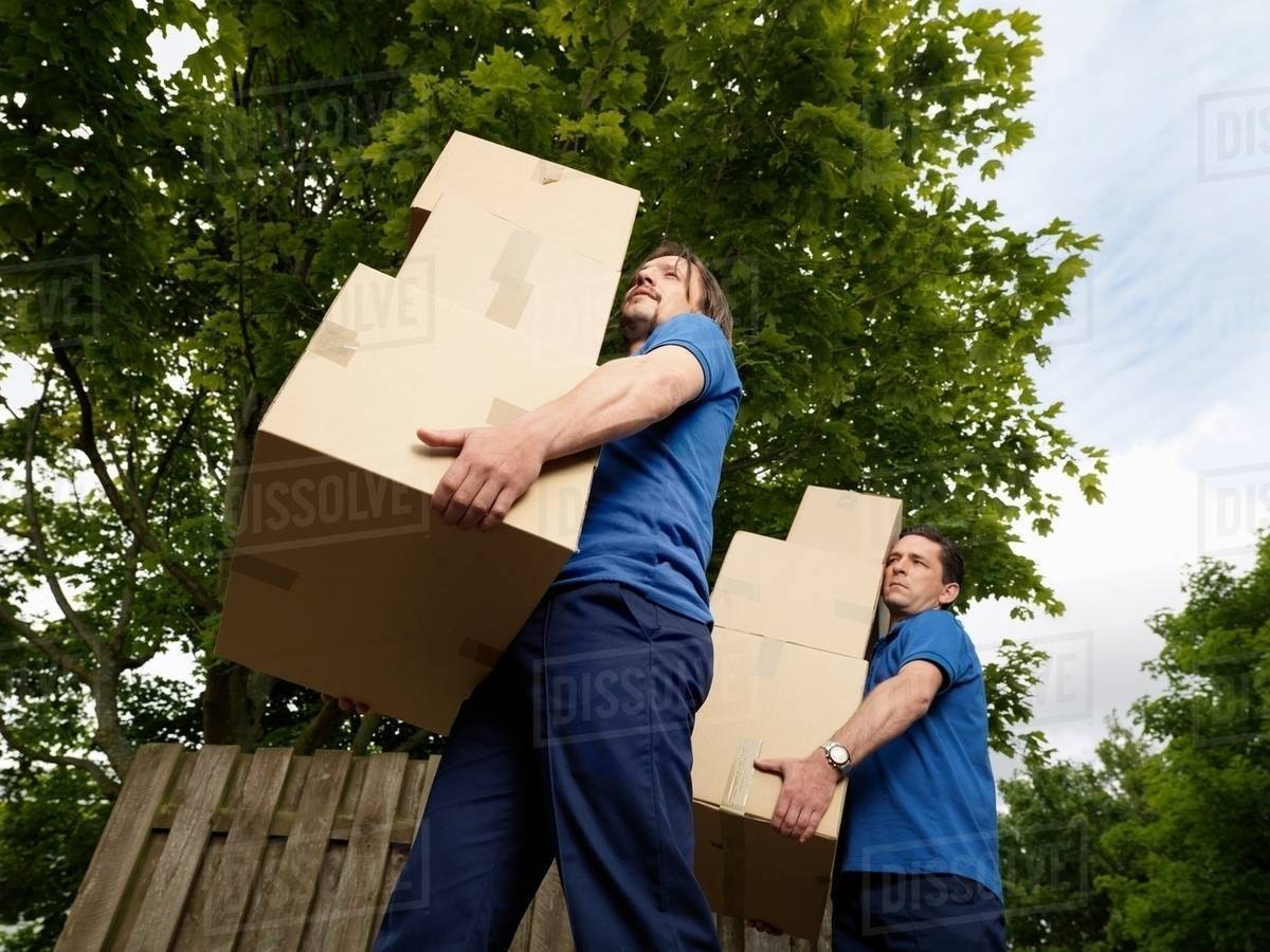 Two men carrying boxes - Royalty-free Stock Photo | Dissolve