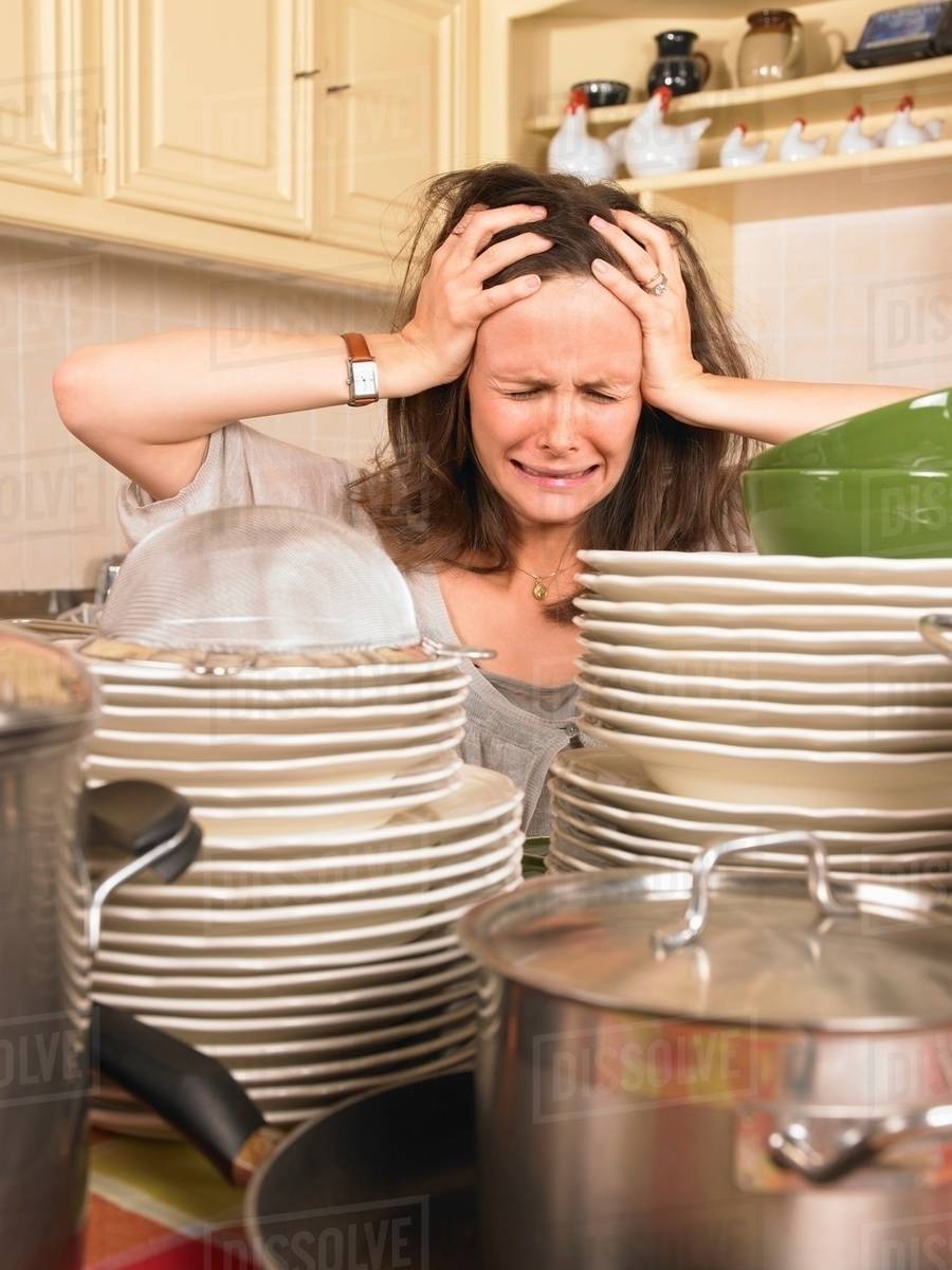 Woman with piles of washing up - Royalty-free Stock Photo | Dissolve