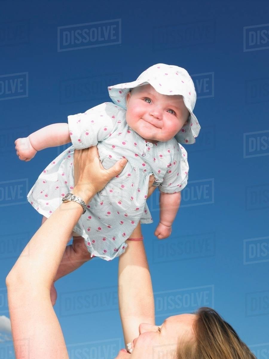 Baby up in the air - Stock Photo - Dissolve