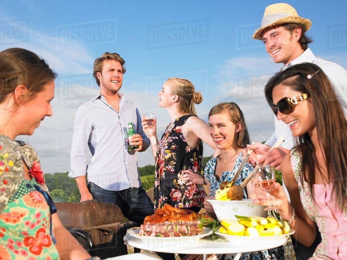 Young people having barbecue - Stock Photo - Dissolve