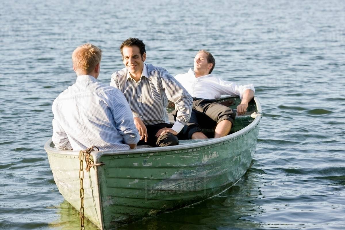 Three businessmen relaxing in rowboat - Royalty-free Stock Photo | Dissolve