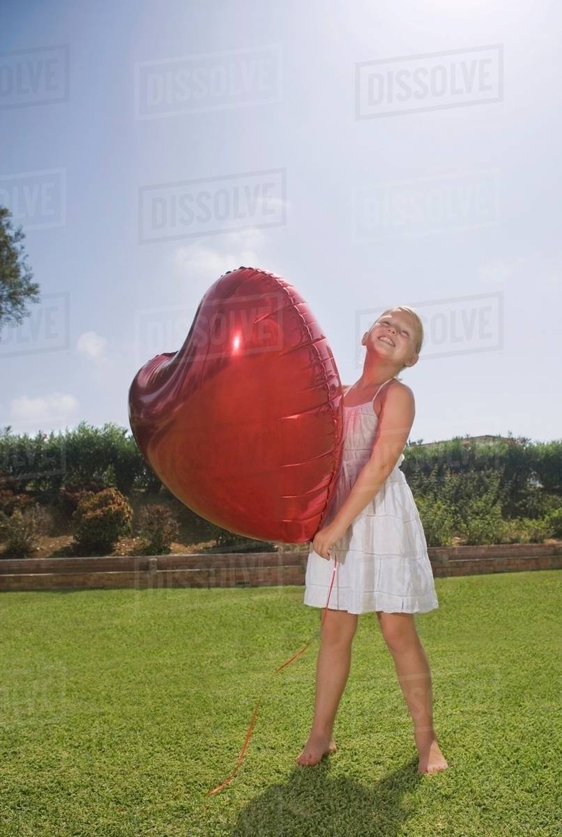 Young girl holding big red heart balloon - Royalty-free Stock Photo ...
