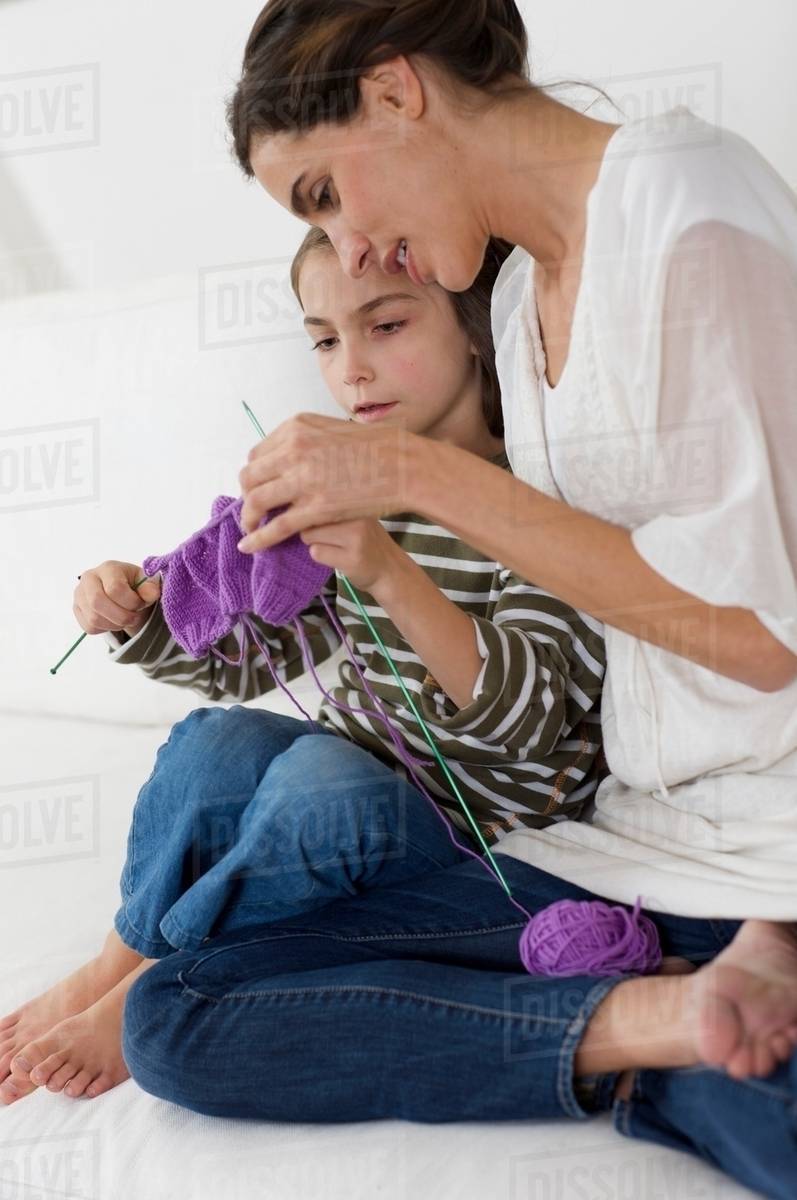 Little girl shown how to knit - Stock Photo - Dissolve