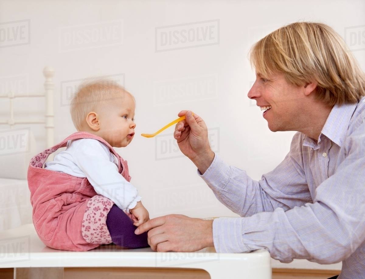 Father feeding baby - Royalty-free Stock Photo | Dissolve