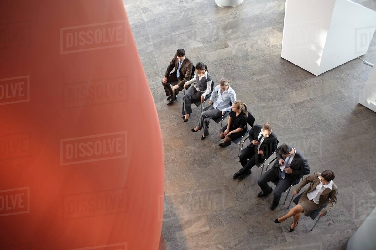 Group of business people sitting in line - Stock Photo - Dissolve