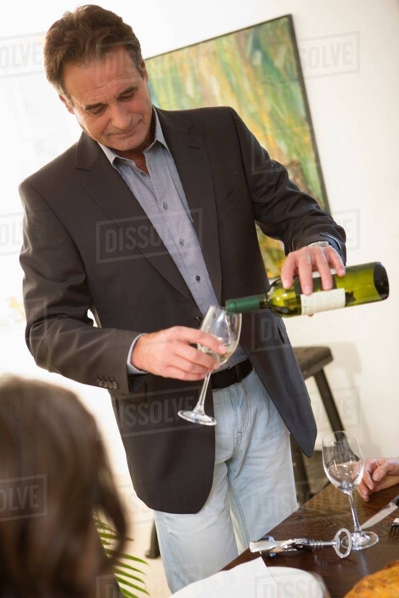 Man serving white whine - Royalty-free Stock Photo | Dissolve