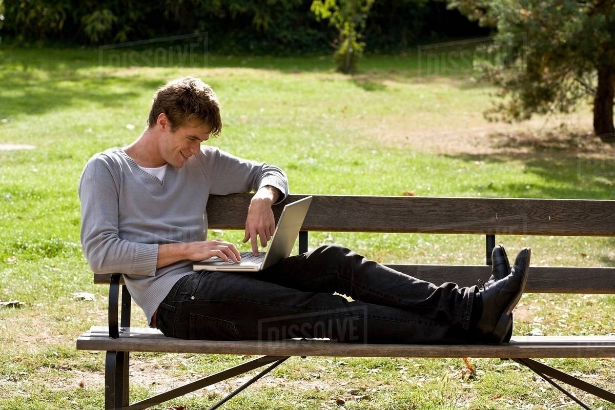 Man using laptop - Stock Photo - Dissolve