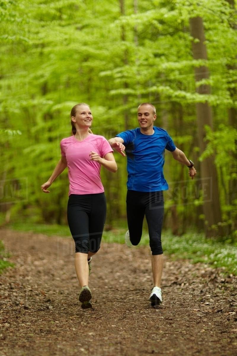 Man and woman running, competing - Stock Photo - Dissolve