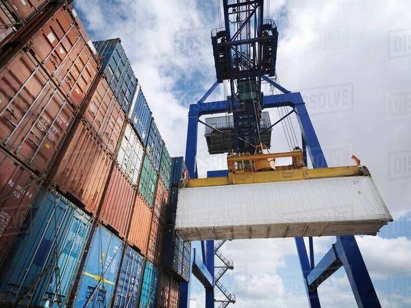 Shipping containers with gantry crane - Stock Photo - Dissolve