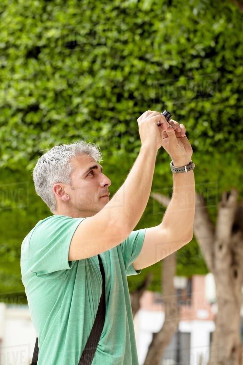 Man taking picture with camera - Royalty-free Stock Photo | Dissolve