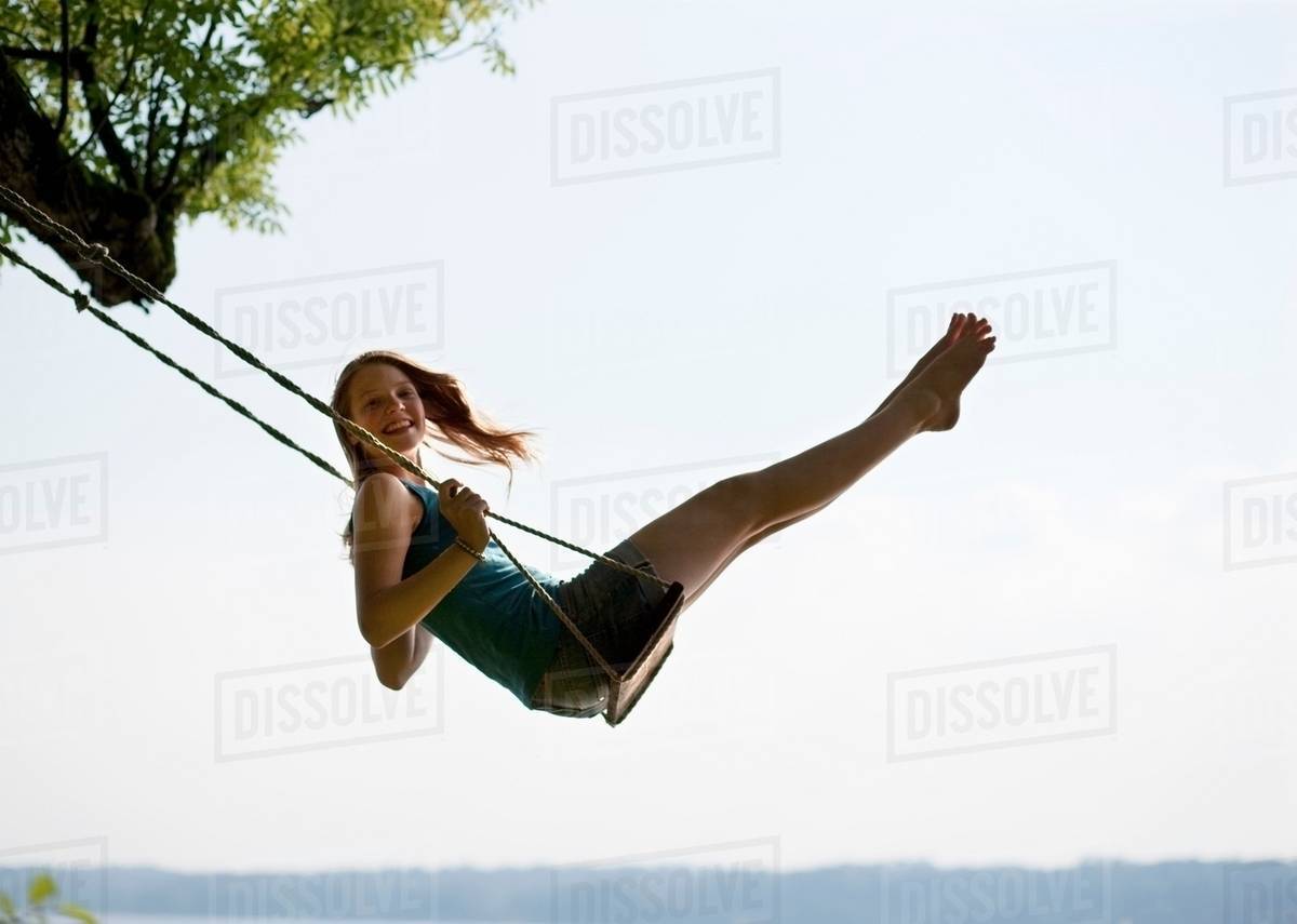 Girl on swing - Stock Photo - Dissolve