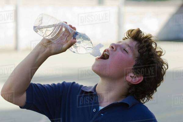 Boy drinking water from a bottle - Royalty-free Stock Photo | Dissolve