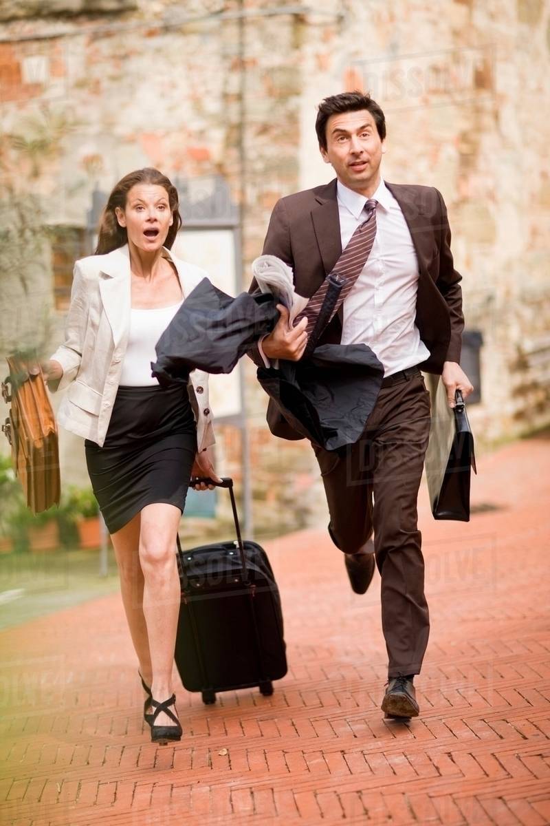 Businessman and woman in a rush - Stock Photo - Dissolve
