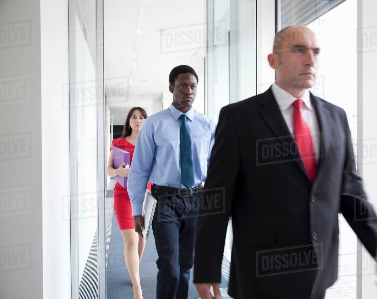 Business people walking down corridor - Royalty-free Stock Photo | Dissolve