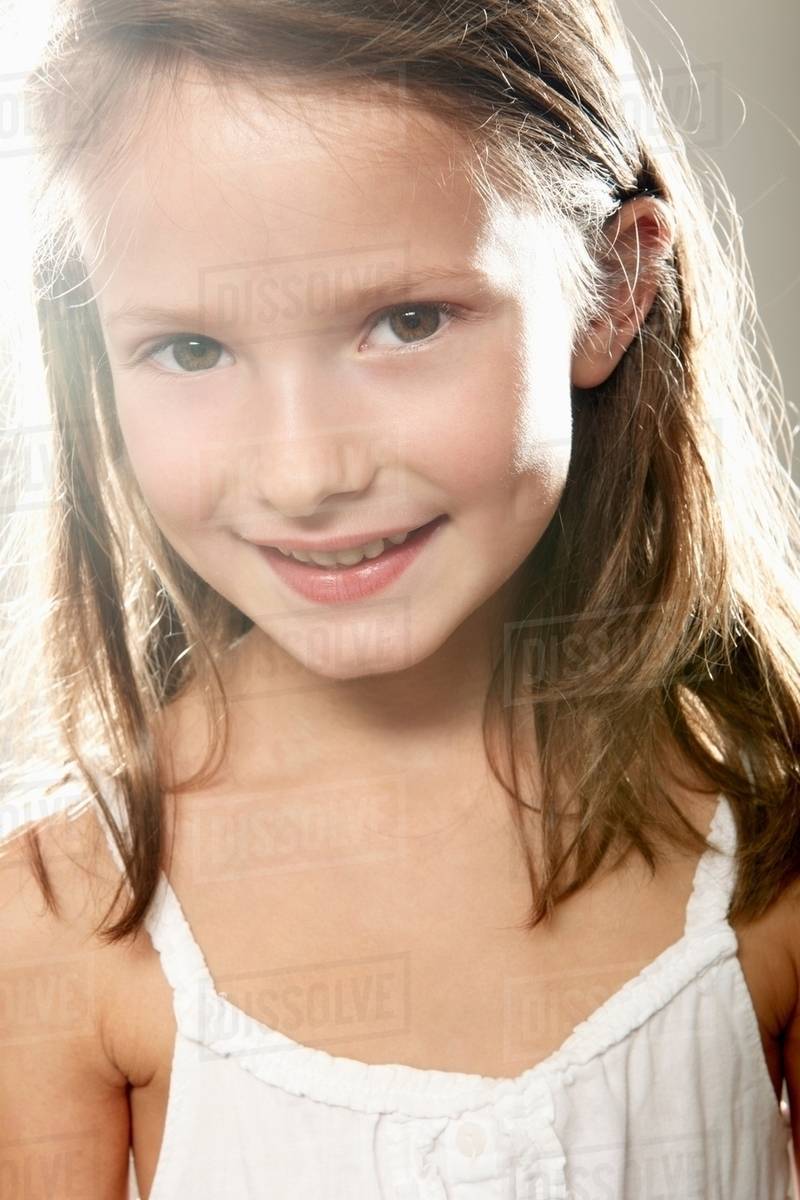 Girl smiling at camera - Stock Photo - Dissolve