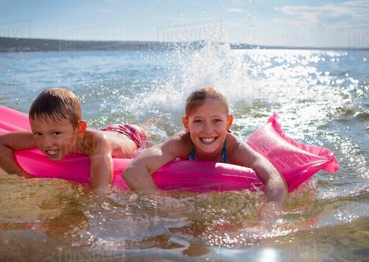 Children swimming with inflatable - Royalty-free Stock Photo | Dissolve