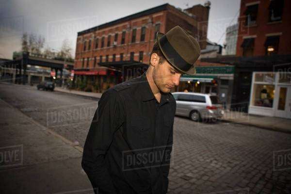 Man walking on city street - Stock Photo - Dissolve