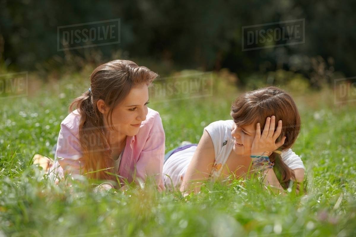2 girls having fun together in a park - Stock Photo - Dissolve