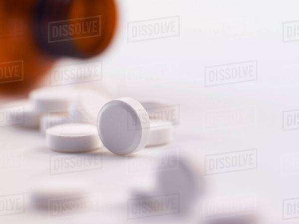 Pain killer pills spilling out of a bottle - Royalty-free Stock Photo ...