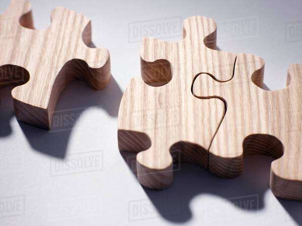 Wooden jigsaw pieces - Stock Photo - Dissolve