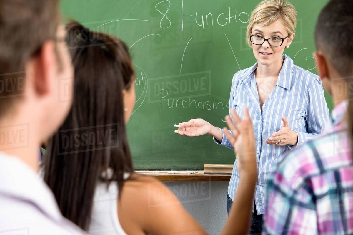 Teacher addressing students in classroom - Royalty-free Stock Photo ...